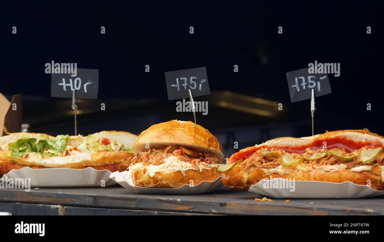 Snack stand at the Prague Farmers Market with a menu on display, a ...