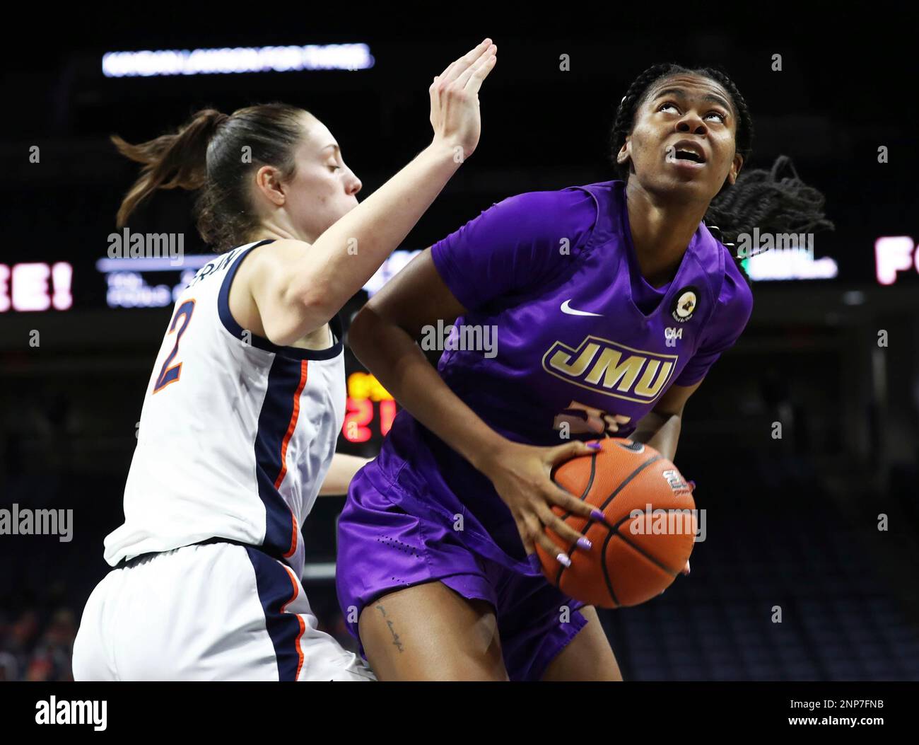 James Madison forward Rayne Tucker (21) eyes the basket, as Virginia's ...