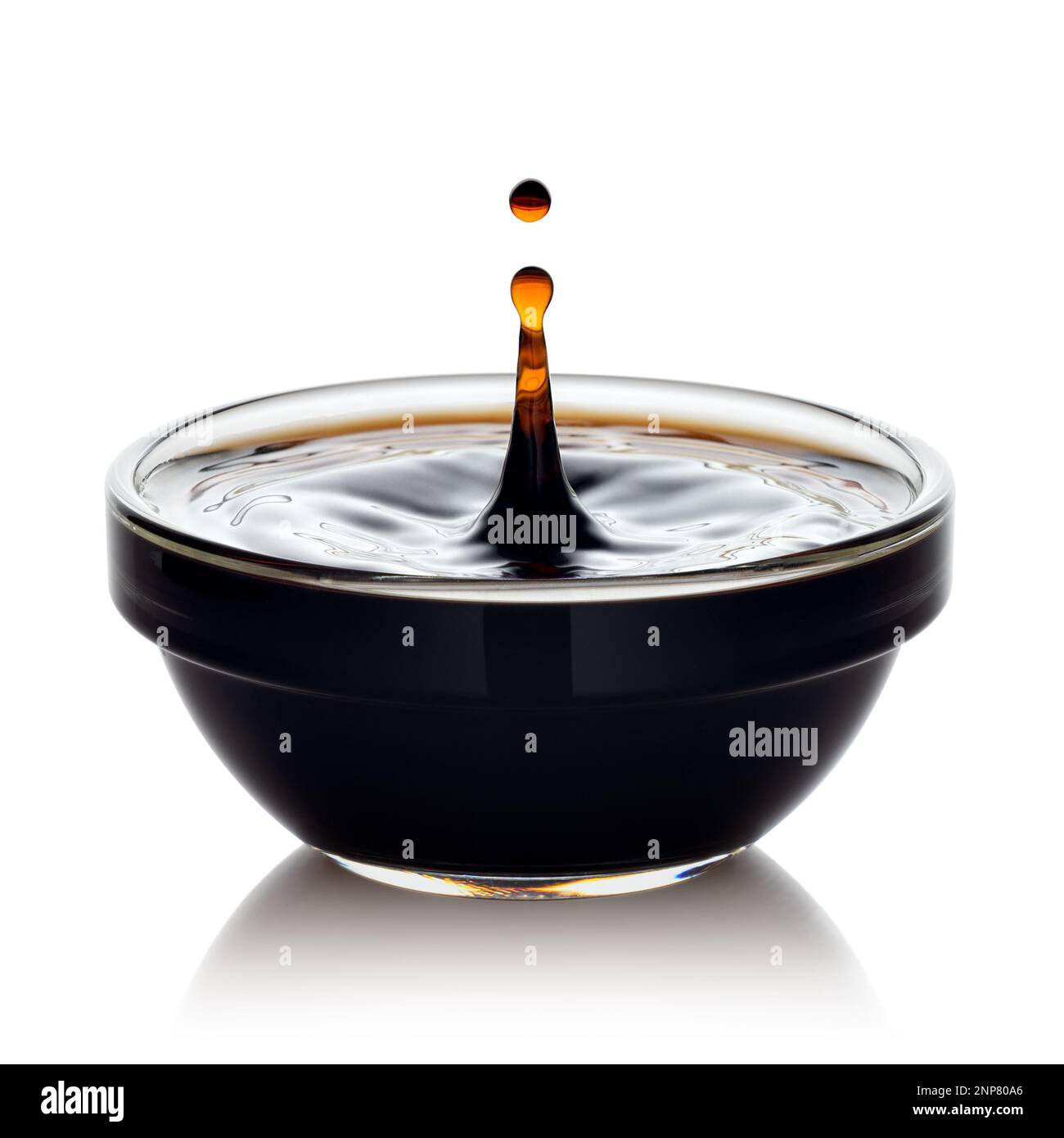 soy sauce with spalsh and drop in glass bowl isolated on white ...