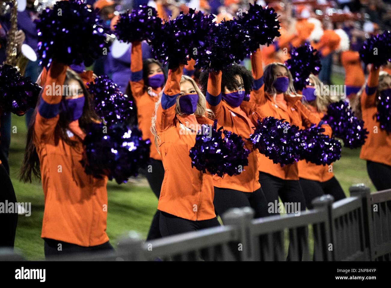 Clemson cheerleaders, wearing masks, perform during the team's NCAA college football game ...