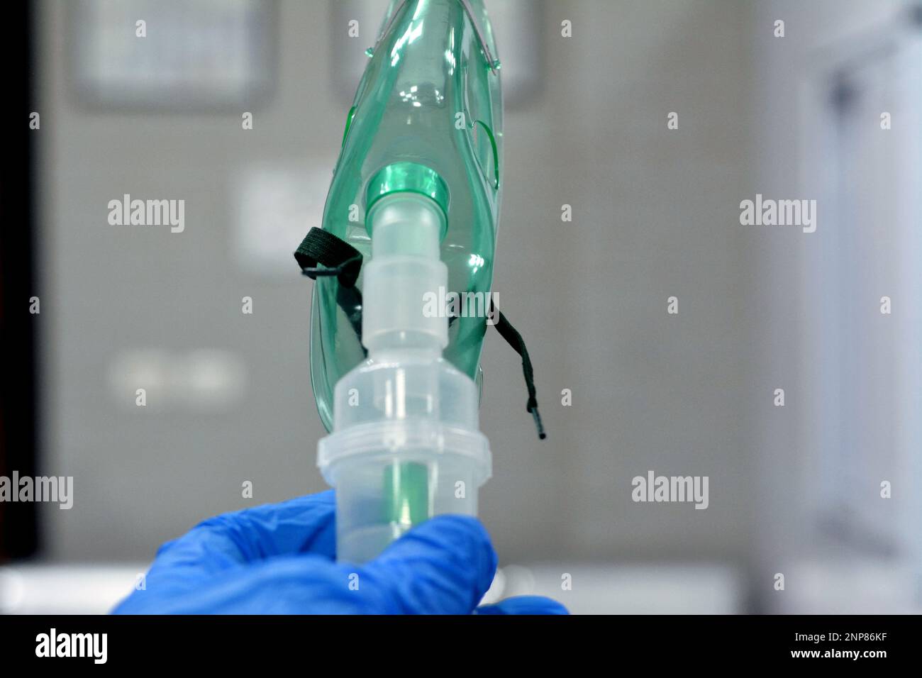 A nebulizer or nebuliser mask that is connected to oxygen cylinder or a ...