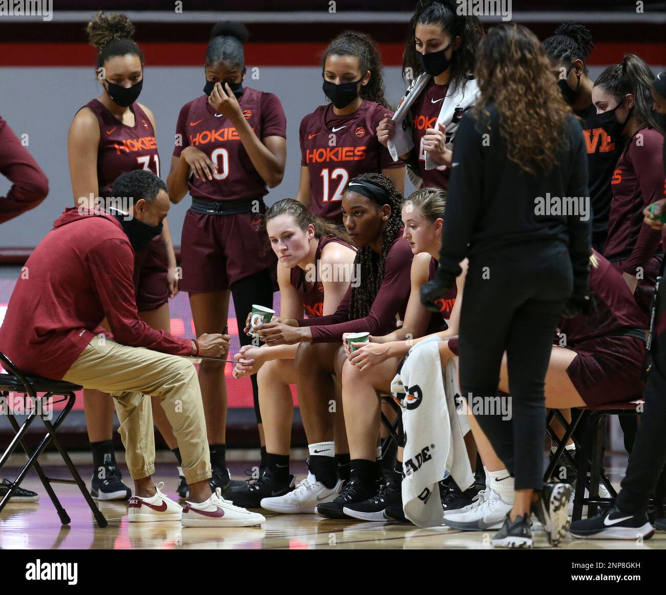 Virginia Tech head coach Kenny Brooks huddles with his team during the ...