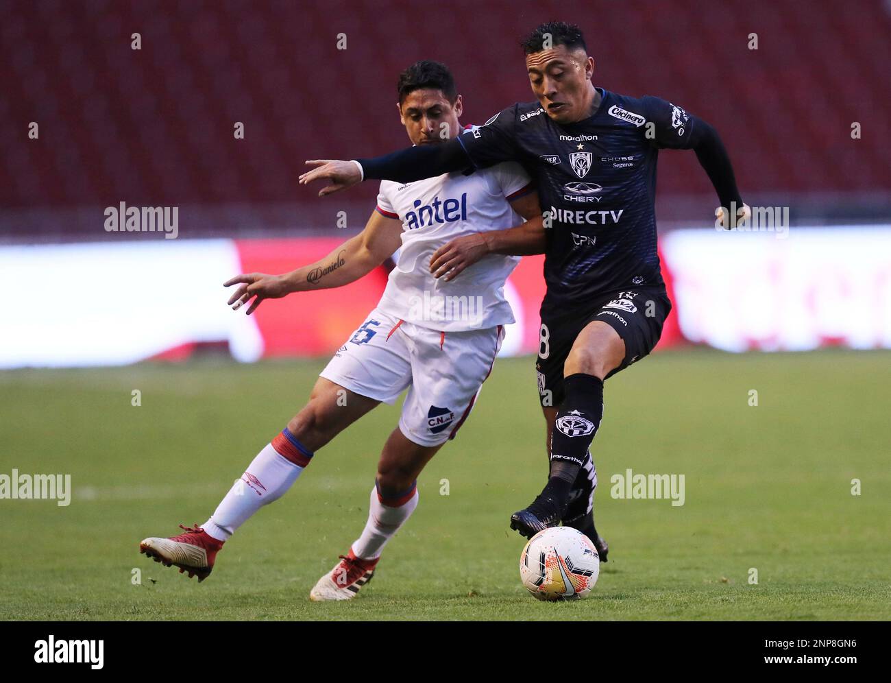 Armando Mendez of Uruguay's Nacional, left, fights for the ball with ...