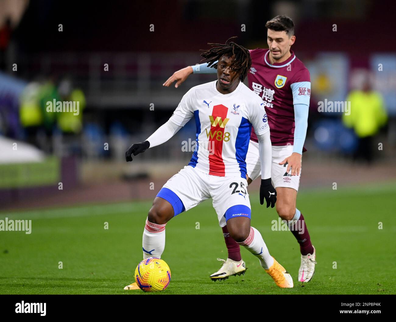 Crystal Palace's Eberechi Eze, front, duels for the ball with Burnley's ...