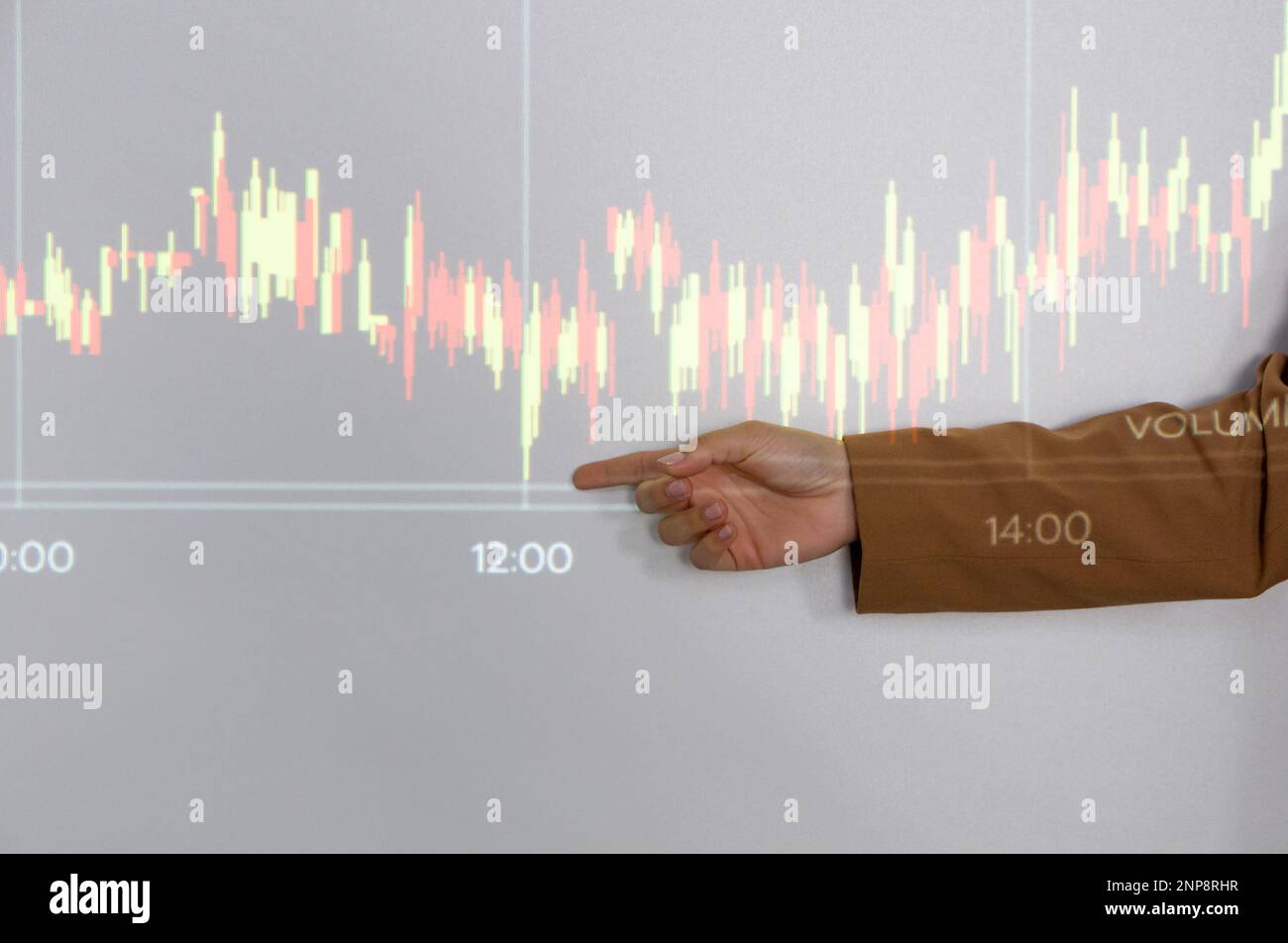 Closeup businesswoman's hand pointing at multicolor chart on ...