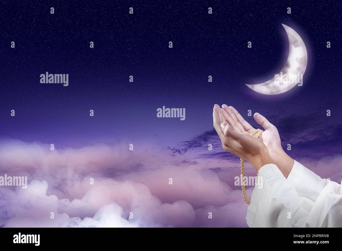 Muslim man praying with prayer beads in his hands with night scene ...