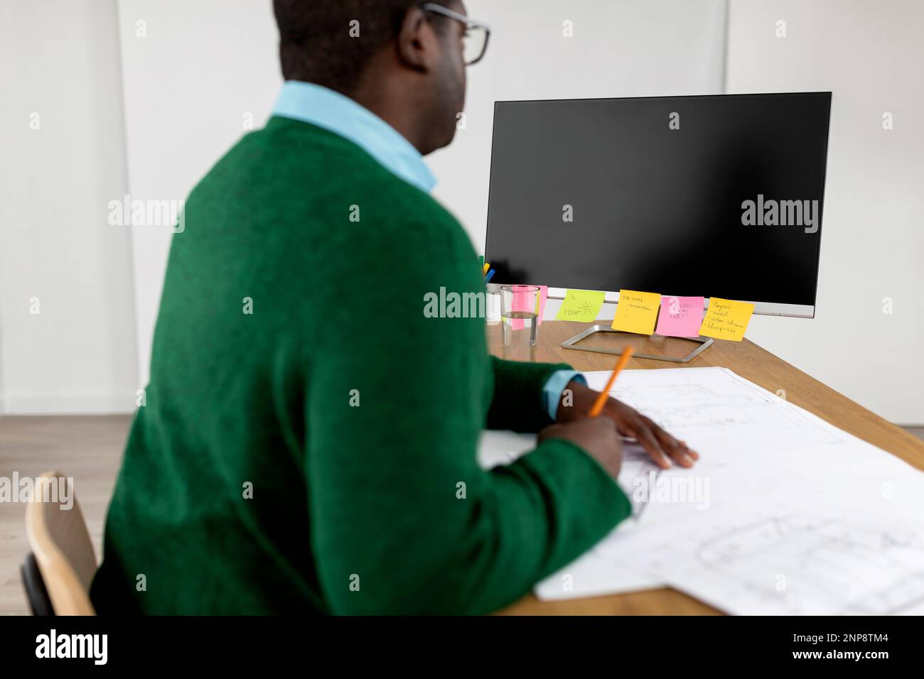 Black Male Drawing Looking At Computer In Office, Rear View Stock Photo ...