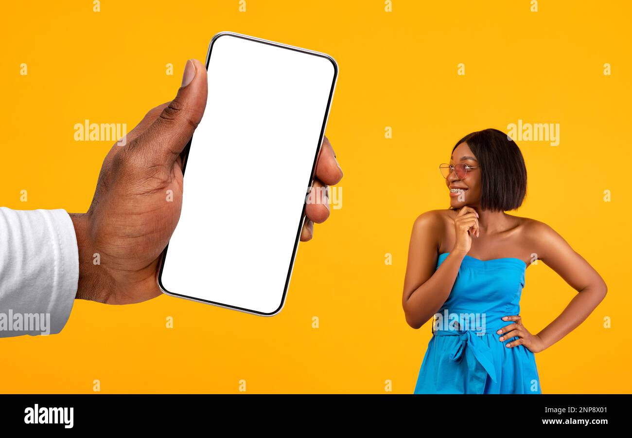Curious Black Female Looking At Blank Smartphone In Huge Male Hand ...