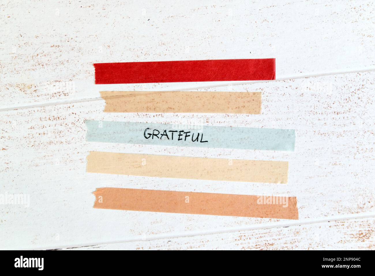 motivational message handwritten on colorful washi tape against white ...