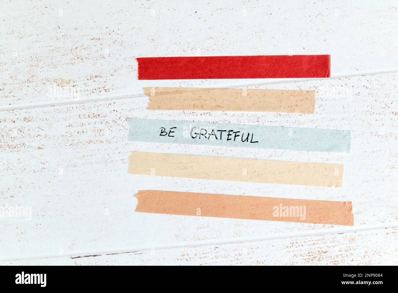 motivational message handwritten on colorful washi tape against white ...