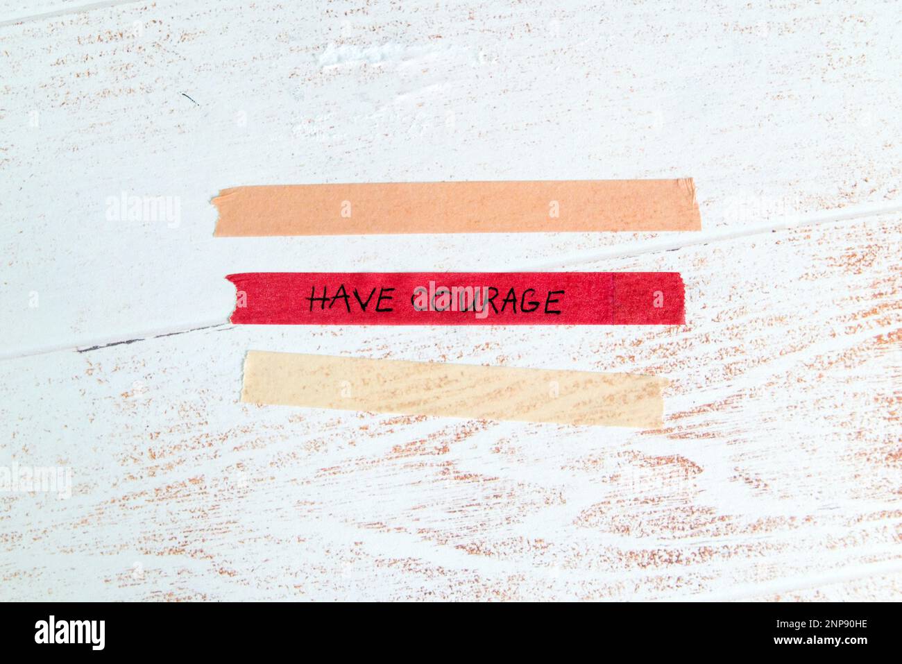 motivational 'have courage' message handwritten on colorful washi tape ...