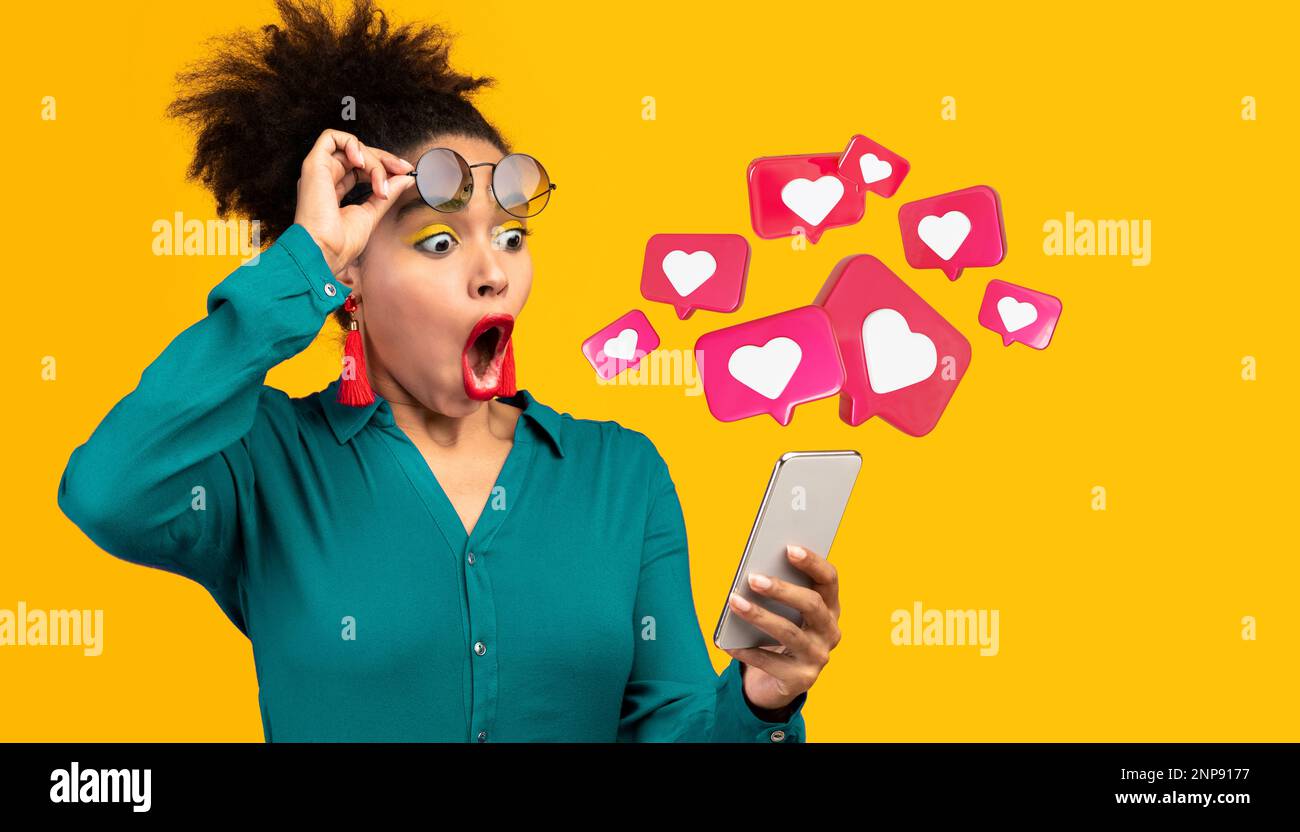 Happy surprised young black lady with open mouth has romantic chat with ...
