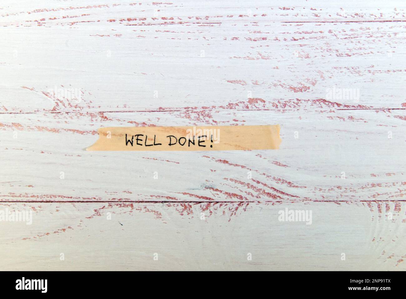 motivational message 'well done' handwritten on colorful washi tape ...