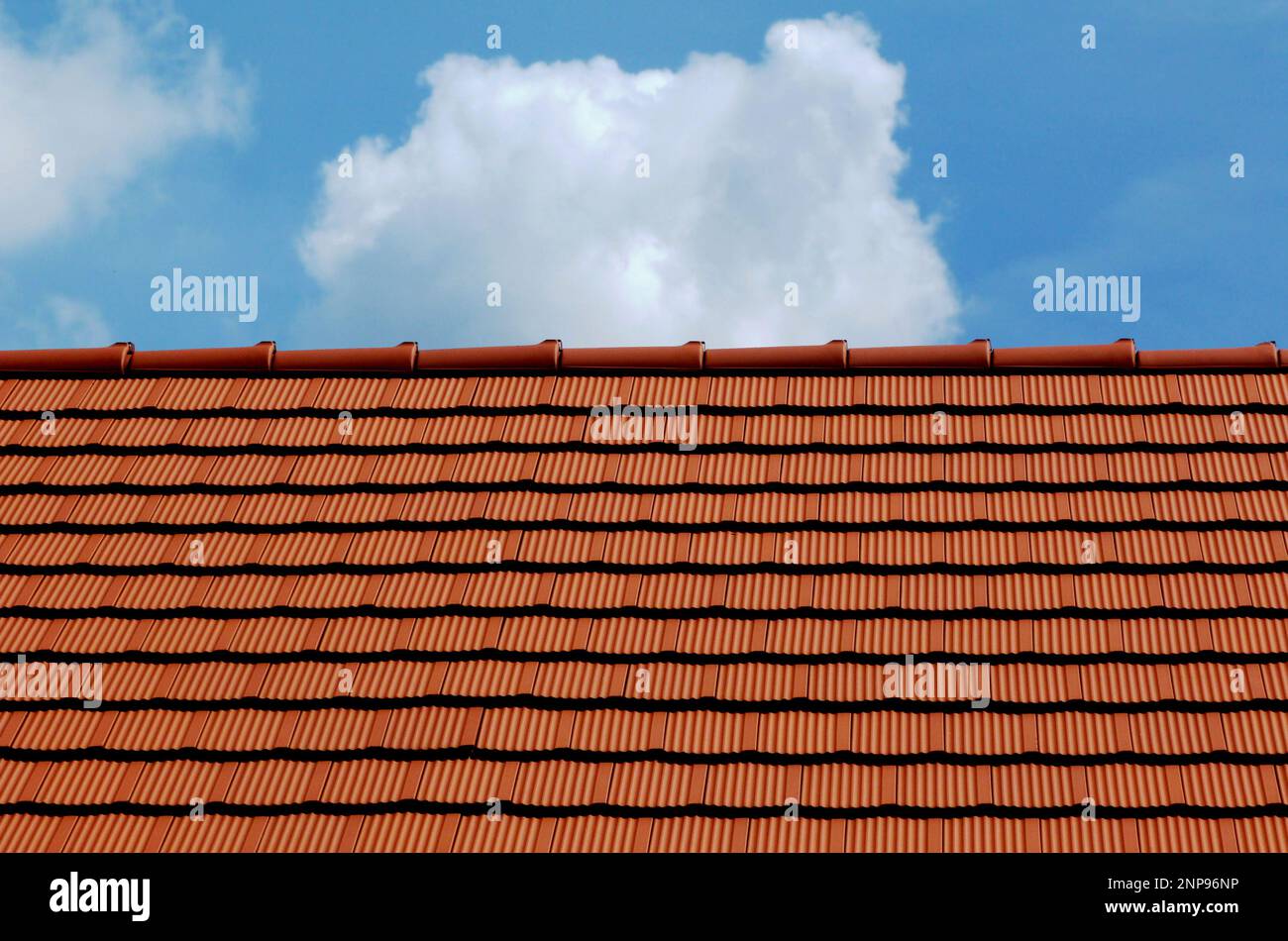 modern bright brown clay tile sloped residential clay roof. blue sky ...