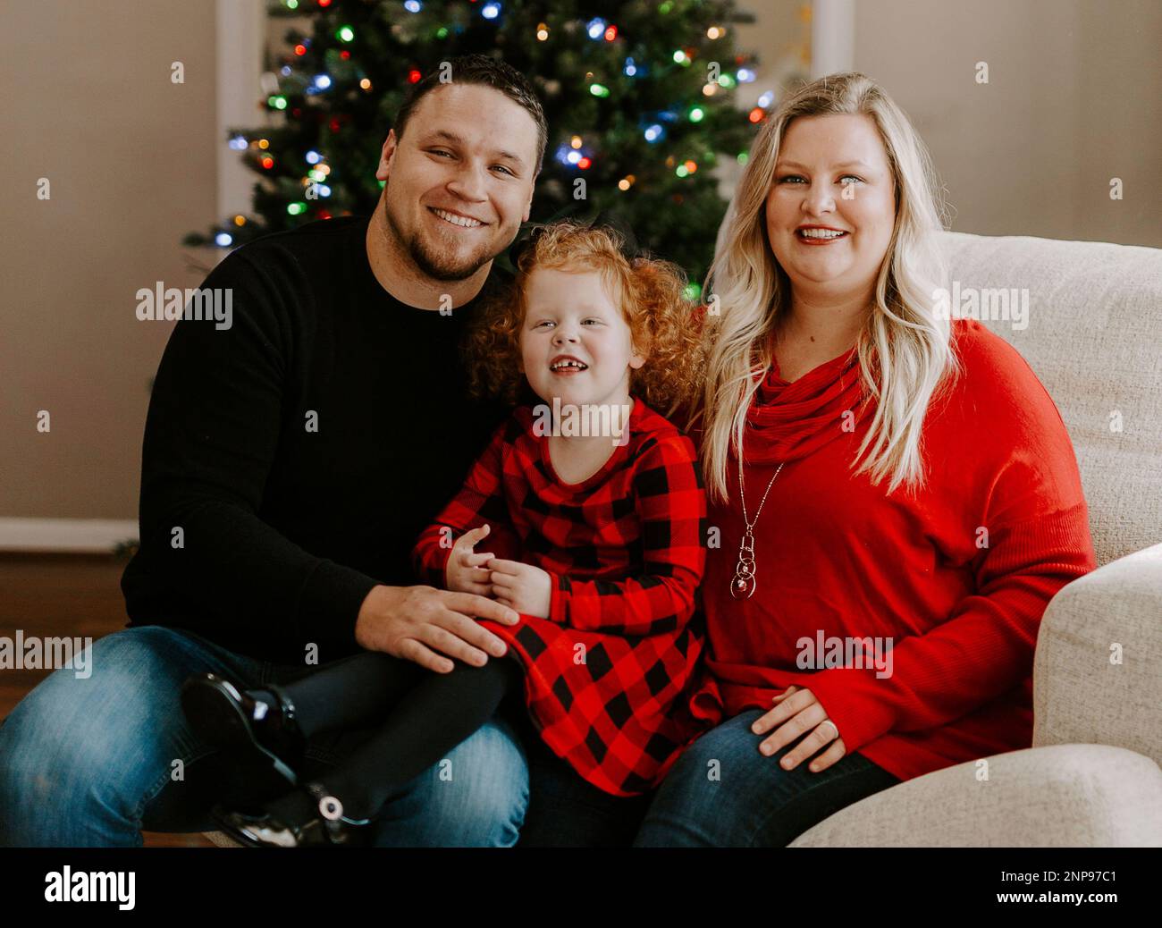 Nick Jones, left, poses with his wife Mindy Jones and their daughter ...