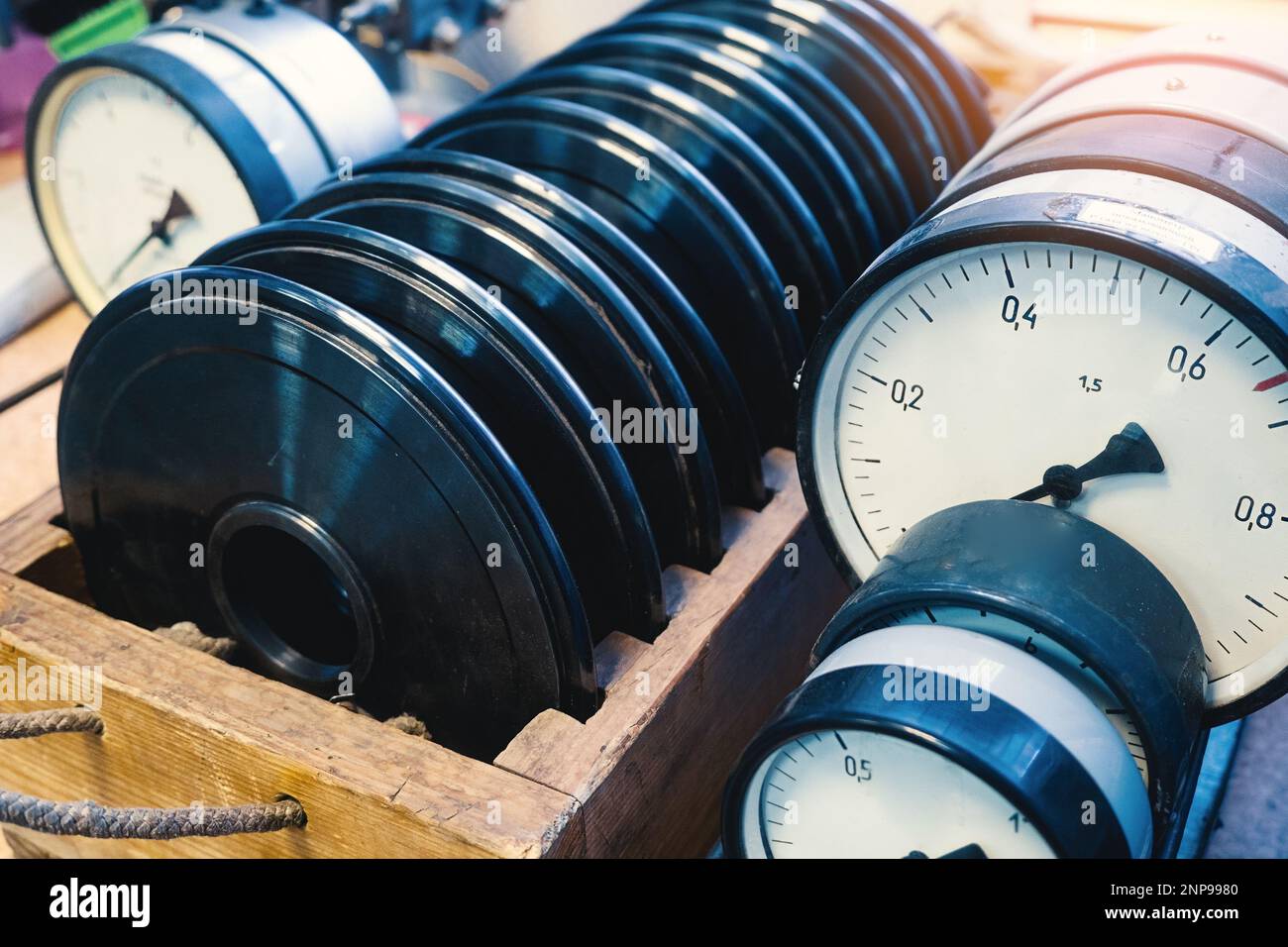Pressure gauges and washers for calibration of instruments lie on ...