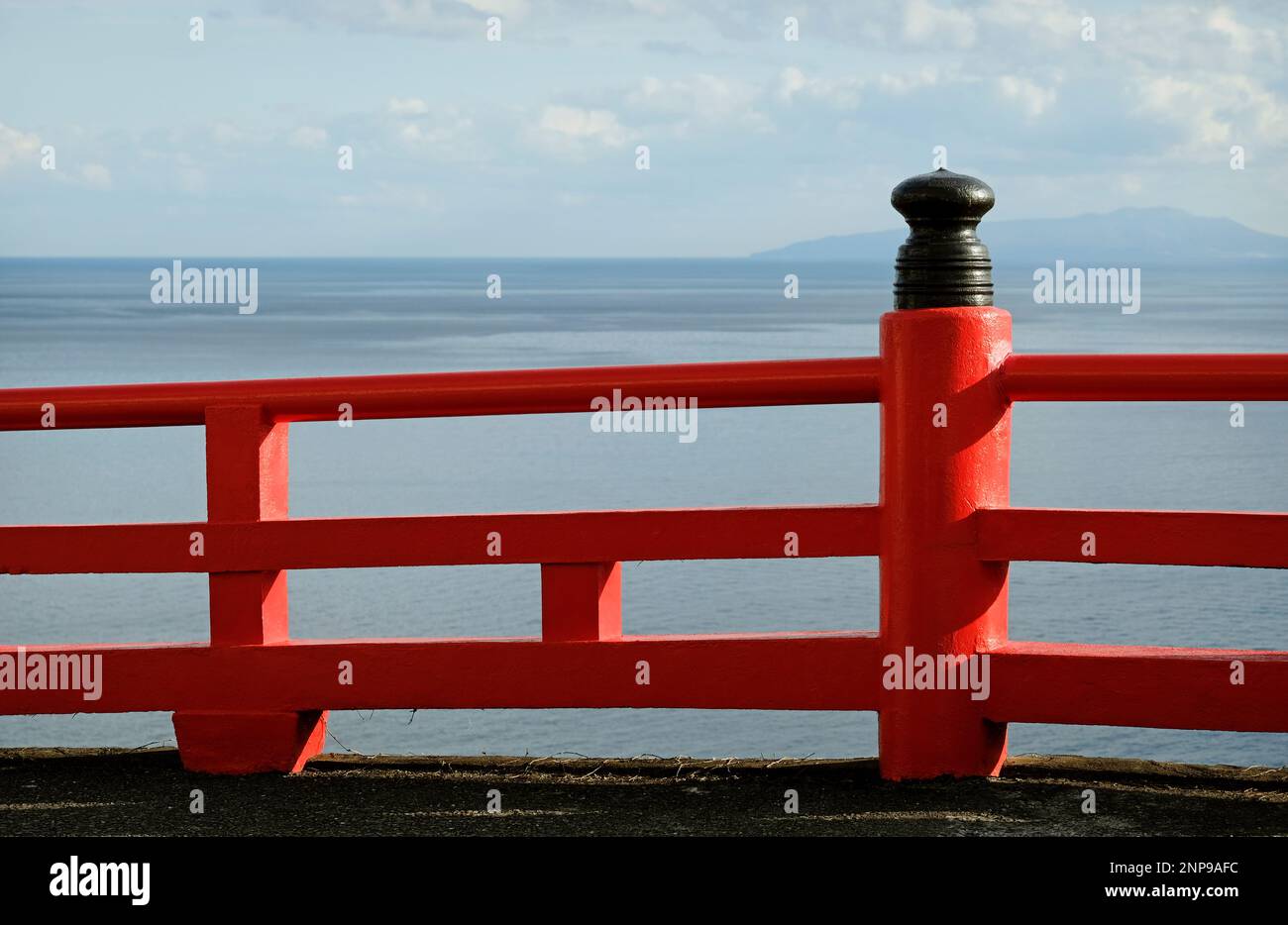 Red fence near the coast with the sea in the background in Enoshima ...