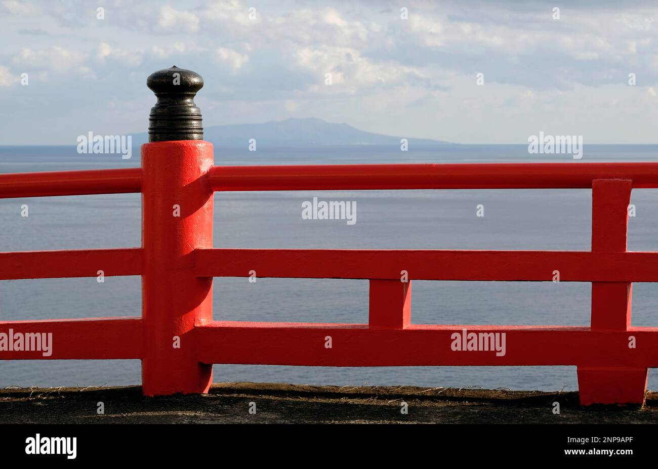 Red fence near the coast with the sea in the background in Enoshima ...