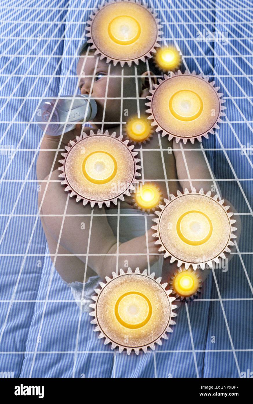INTERLOCKING COG GEARS ABOVE INFANT BABY LAYING DOWN Stock Photo - Alamy
