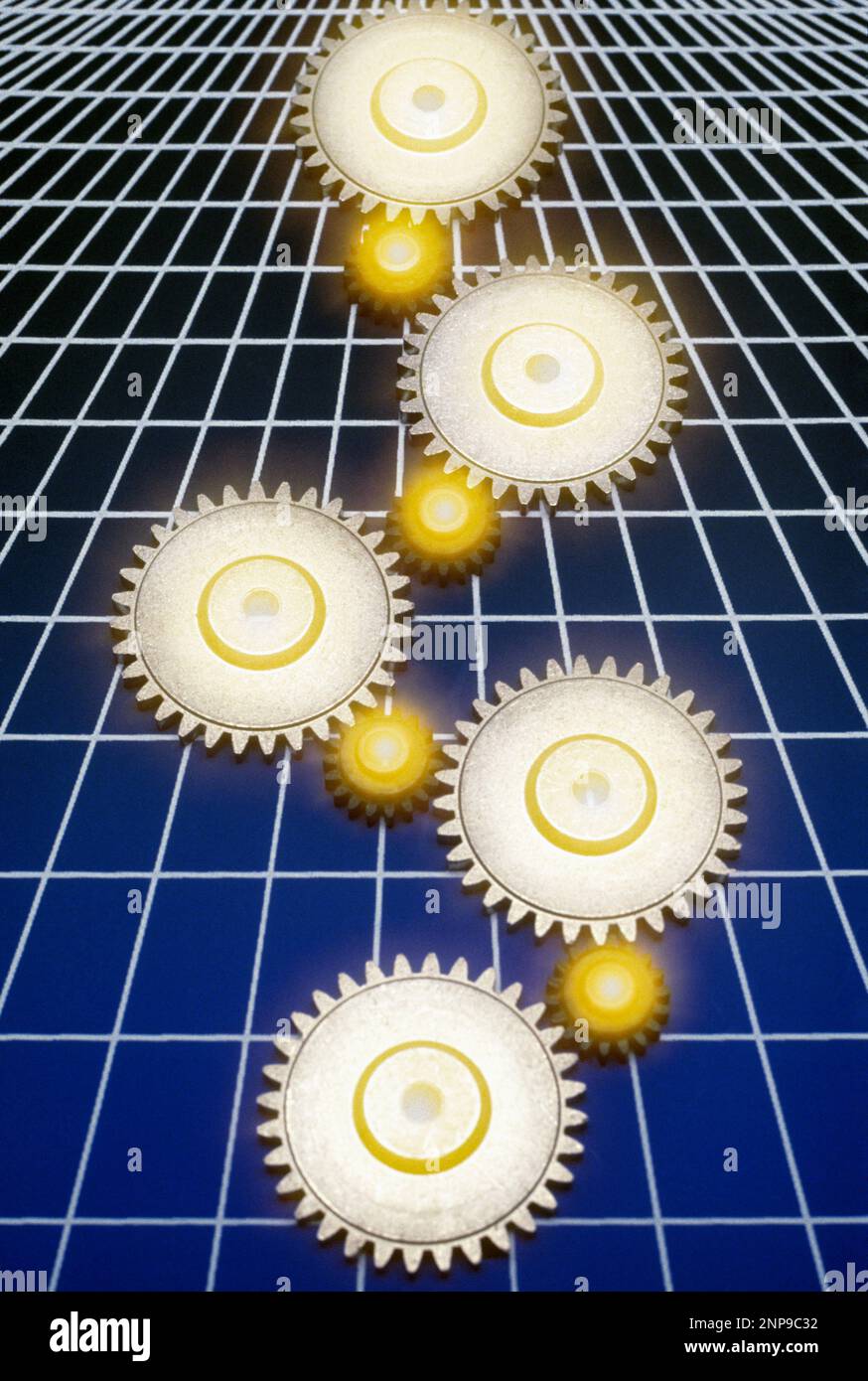 INTERLOCKING COG GEARS ON BLUE GRID Stock Photo - Alamy