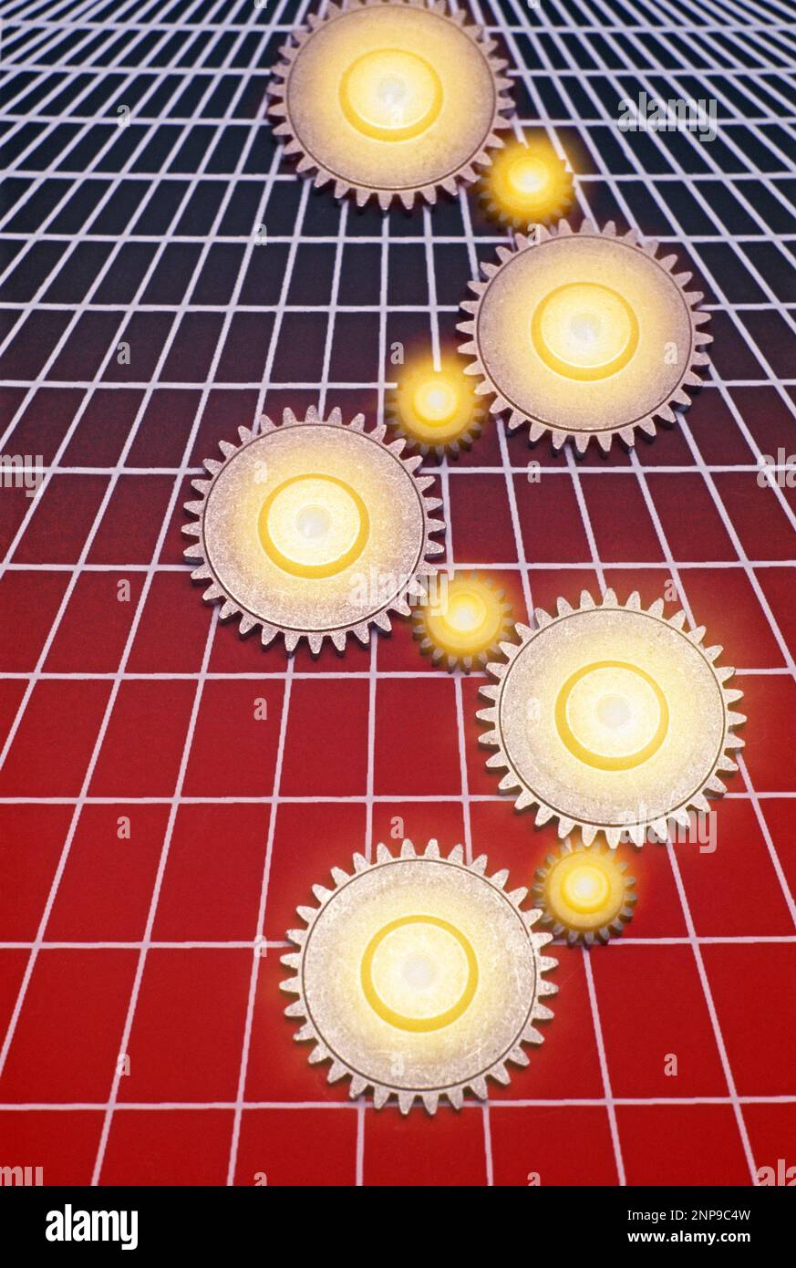 INTERLOCKING COG GEARS ON RED GRID Stock Photo - Alamy