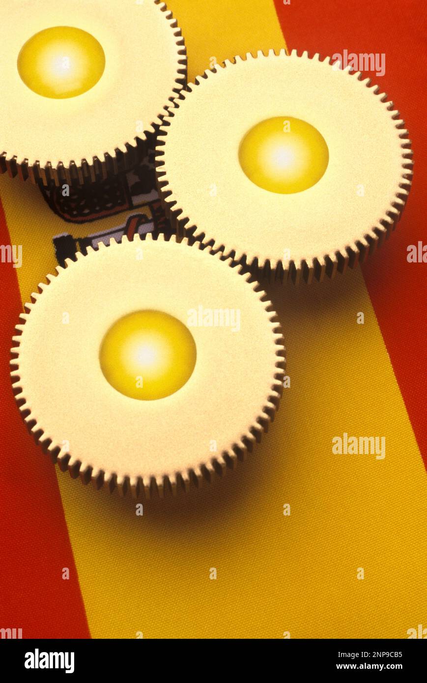 INTERLOCKING GOLDEN COG GEAR WHEELS FLAG OF SPAIN Stock Photo - Alamy