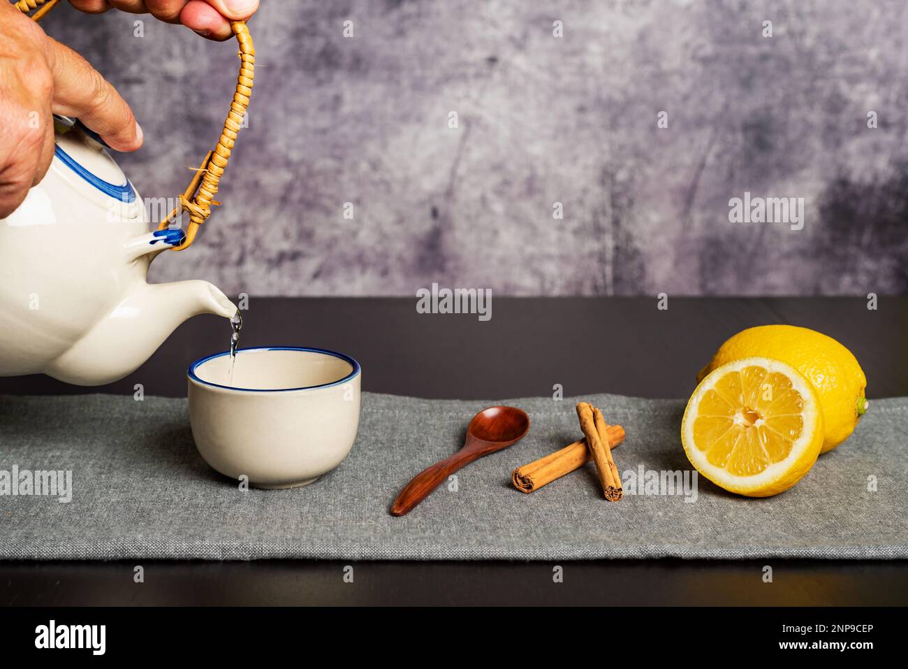 Hands holding teapot hi-res stock photography and images - Alamy