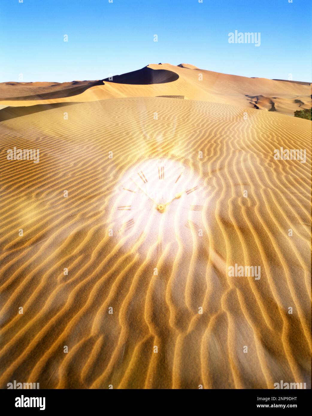 OLD FASHIONED POCKET WATCH SUPERIMPOSED ON RIPPLES IN GIANT DESERT SAND ...
