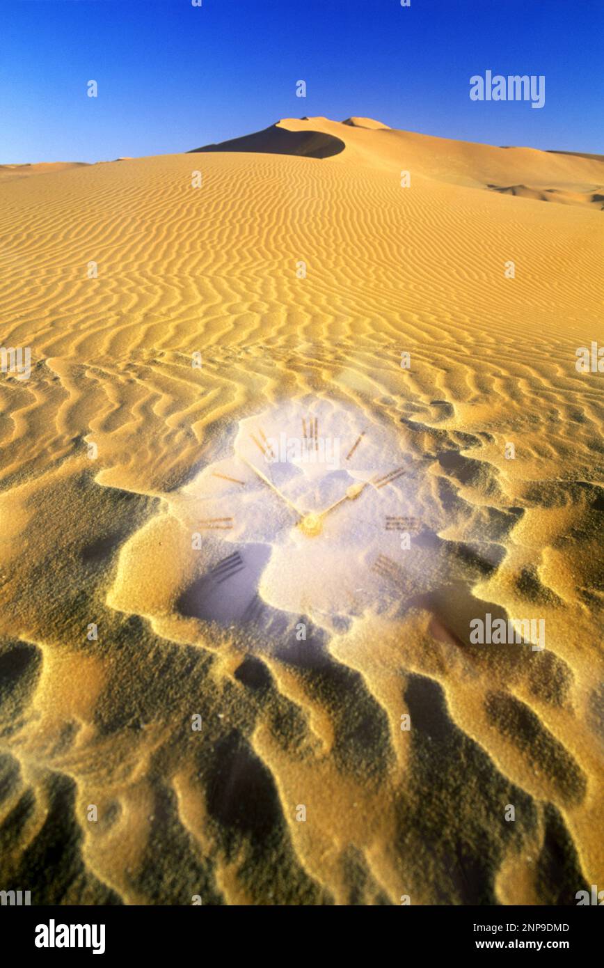 OLD FASHIONED POCKET WATCH SUPERIMPOSED ON RIPPLES IN GIANT DESERT SAND ...