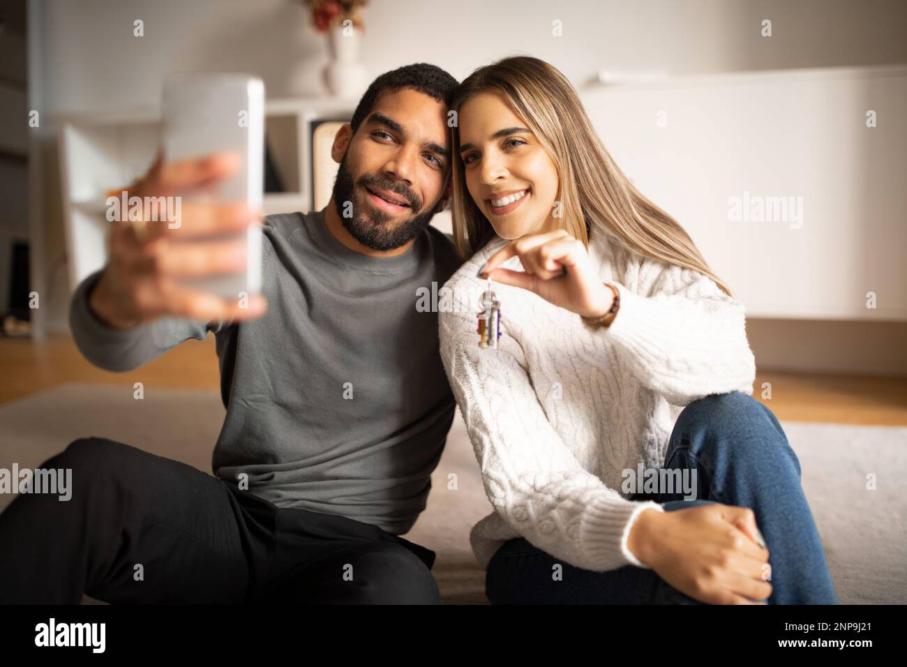 Happy young arab man hug european wife take photo on smartphone and ...
