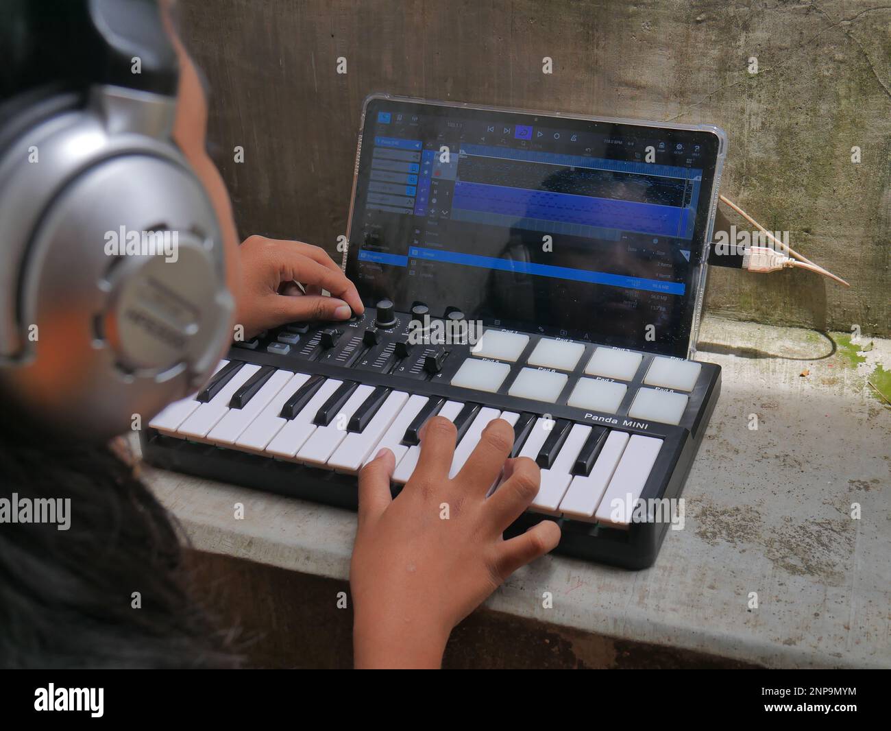 hand playing midi controller and music editing with android application ...