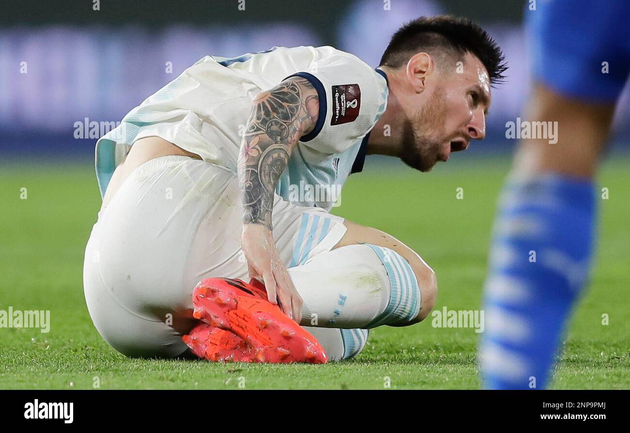 Argentina's Lionel Messi holds his leg during a qualifying soccer match ...