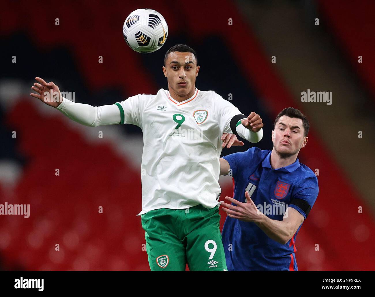 Ireland's Adam Idah shields the ball from England's Michael Keane ...