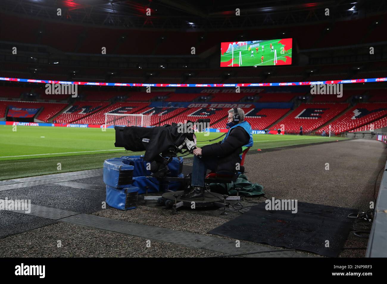 A TV camera operator films the match in an empty stadium during the ...
