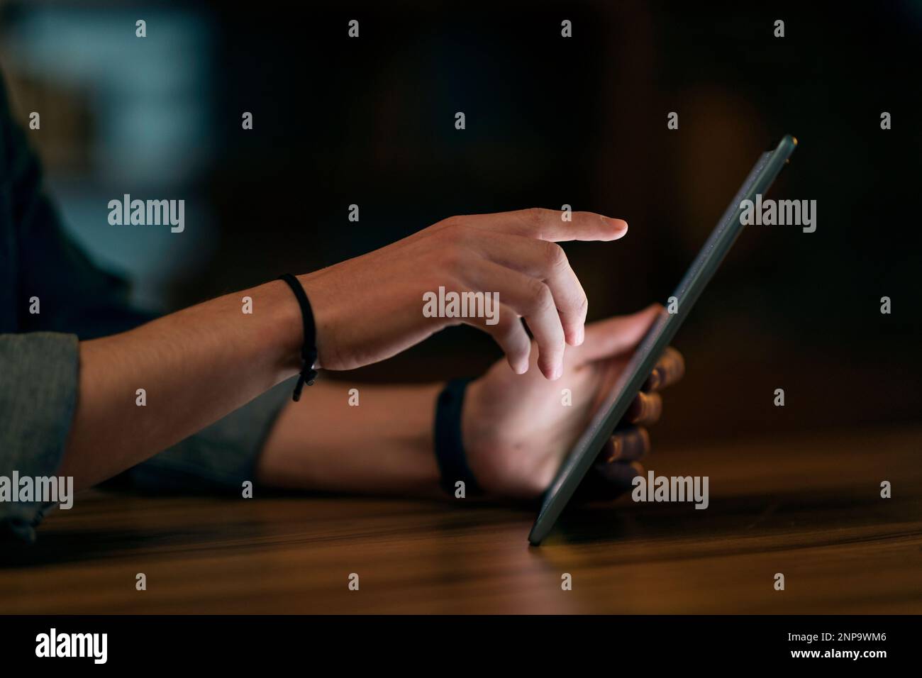 Male hands touching digital pad pc screen, using gadget at night Stock ...