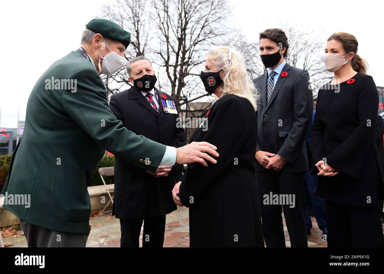 Canadian Korean War Veteran Bill Black places his hand on the arm of ...