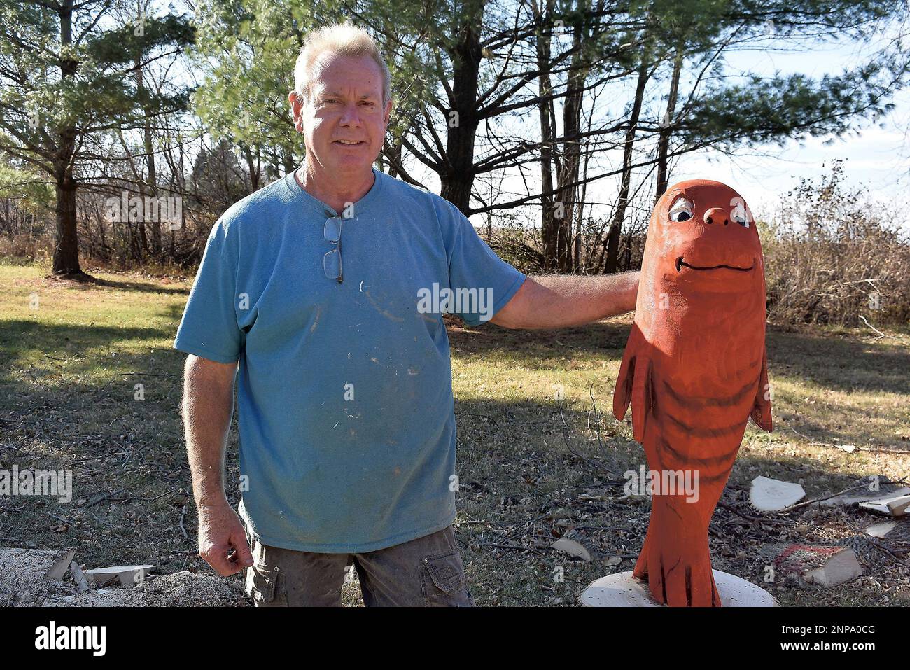 Gary Keenan, a chainsaw sculptor from Des Moines, poses with one of his ...