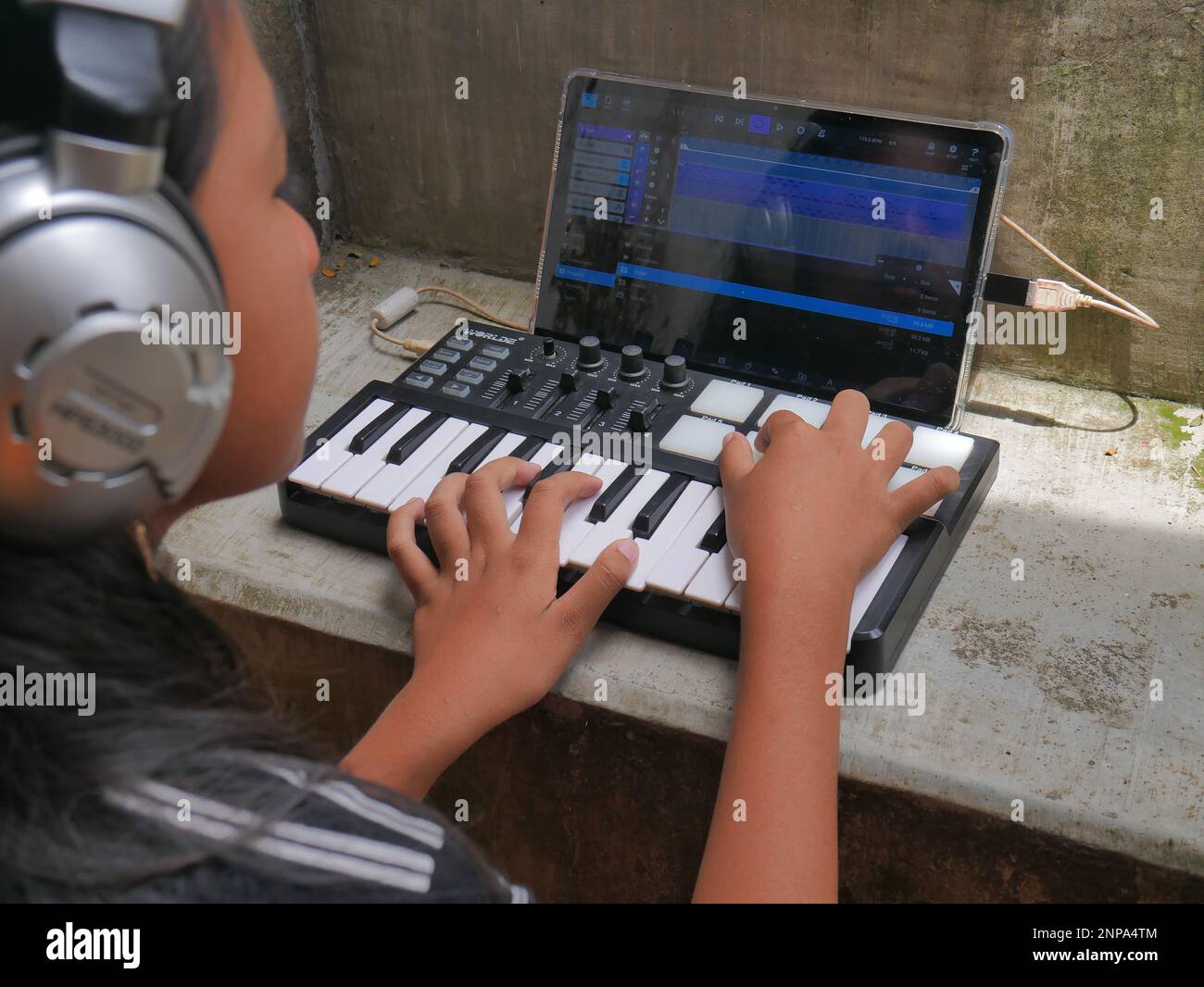 hand playing midi controller and music editing with android application ...