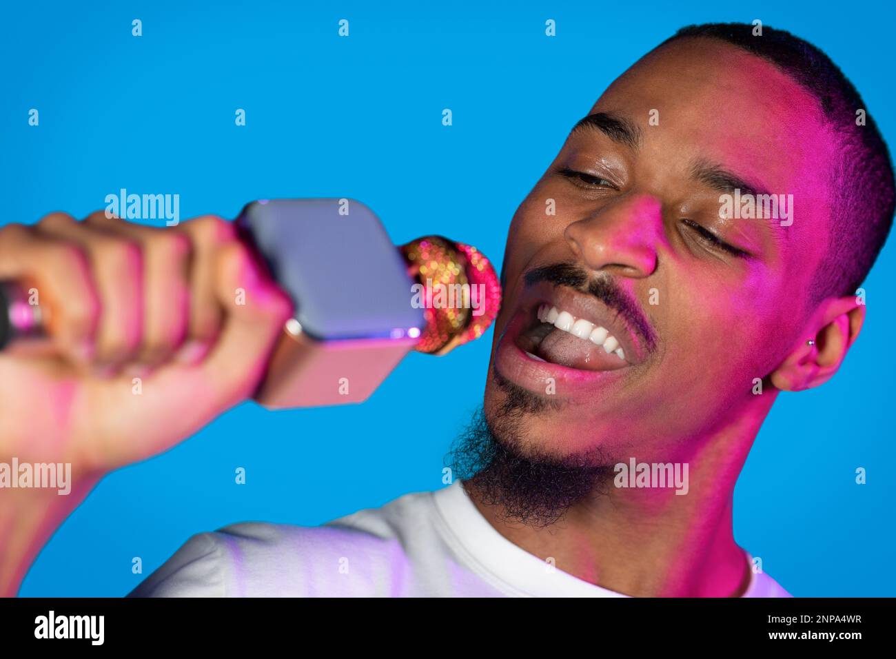 Cool handsome black guy with microphone in his hand singing Stock Photo ...