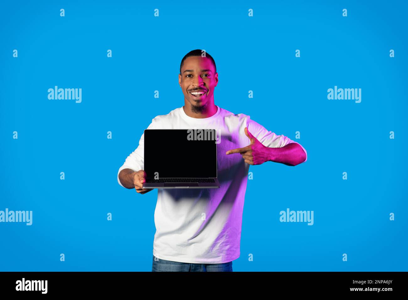 Cheerful african american guy pointing at computer blank screen Stock ...
