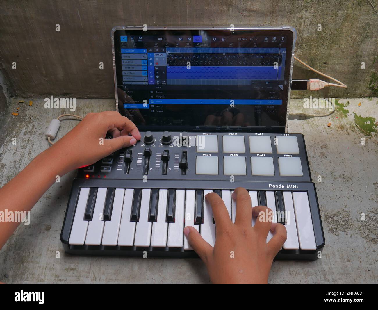 hand playing midi controller and music editing with android application ...