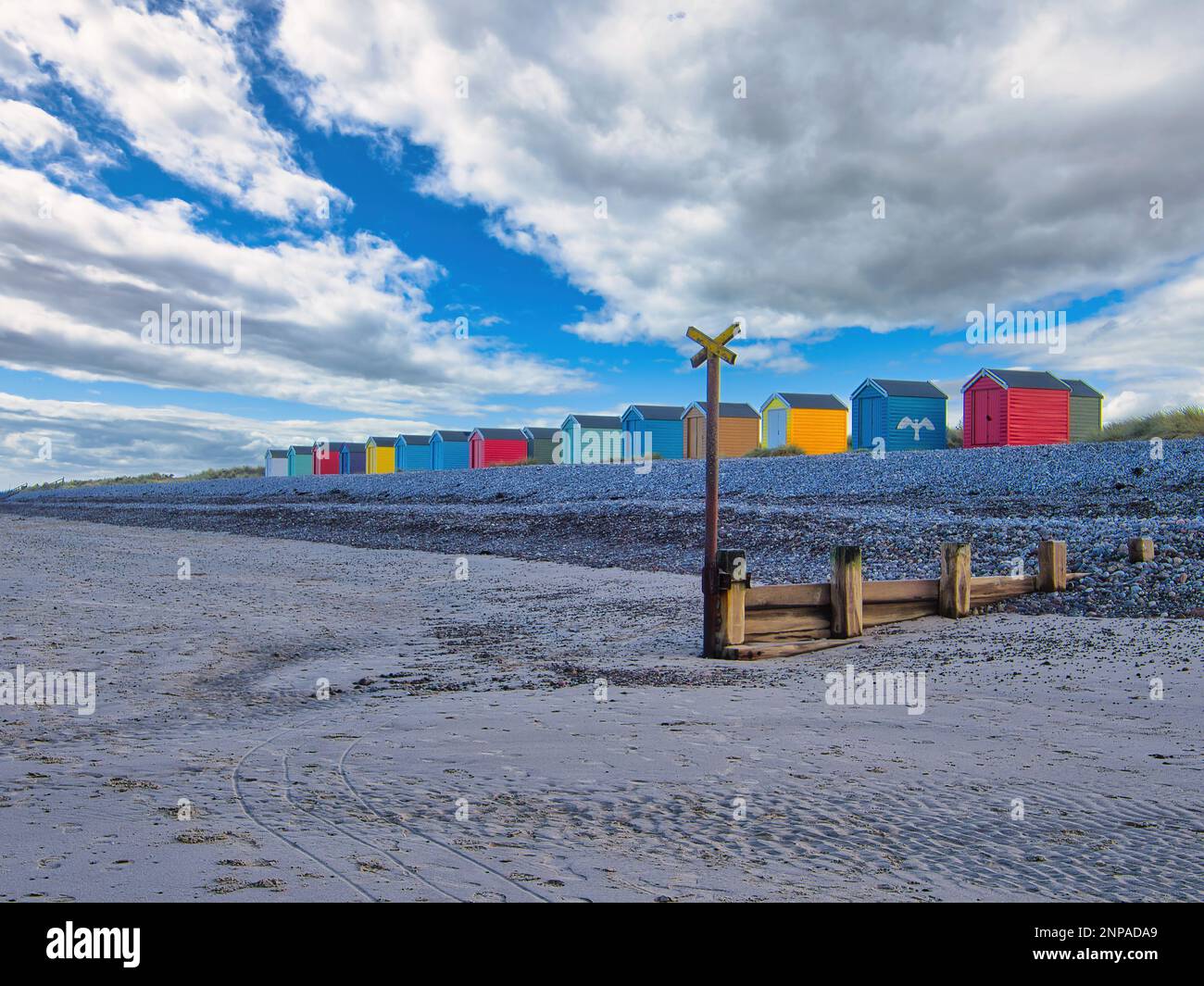 The row of beautifully vibrant beach huts at Findhorn in Scotland under ...
