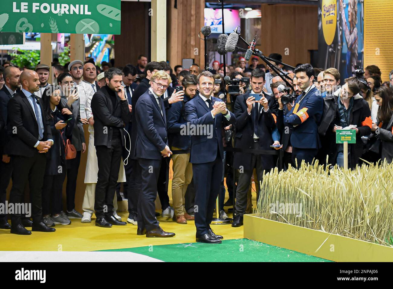 French President Emmanuel Macron from back speaks with journalists with ...