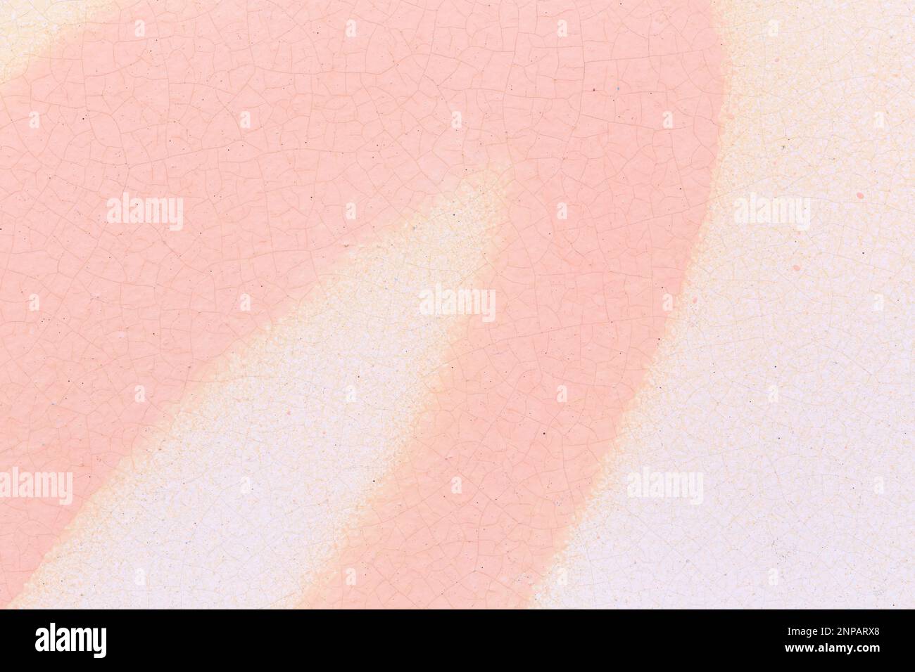 Macro close-up of beige spray paint with splashes on a white wall ...