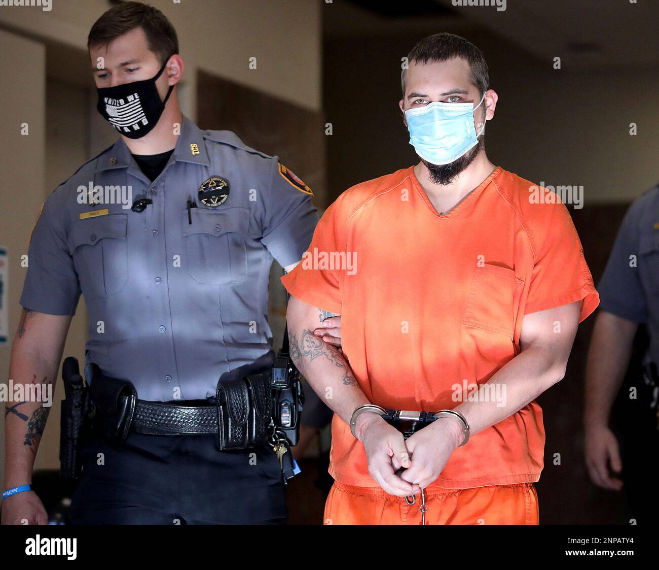 David Ware is led away from a courtroom after a district court ...