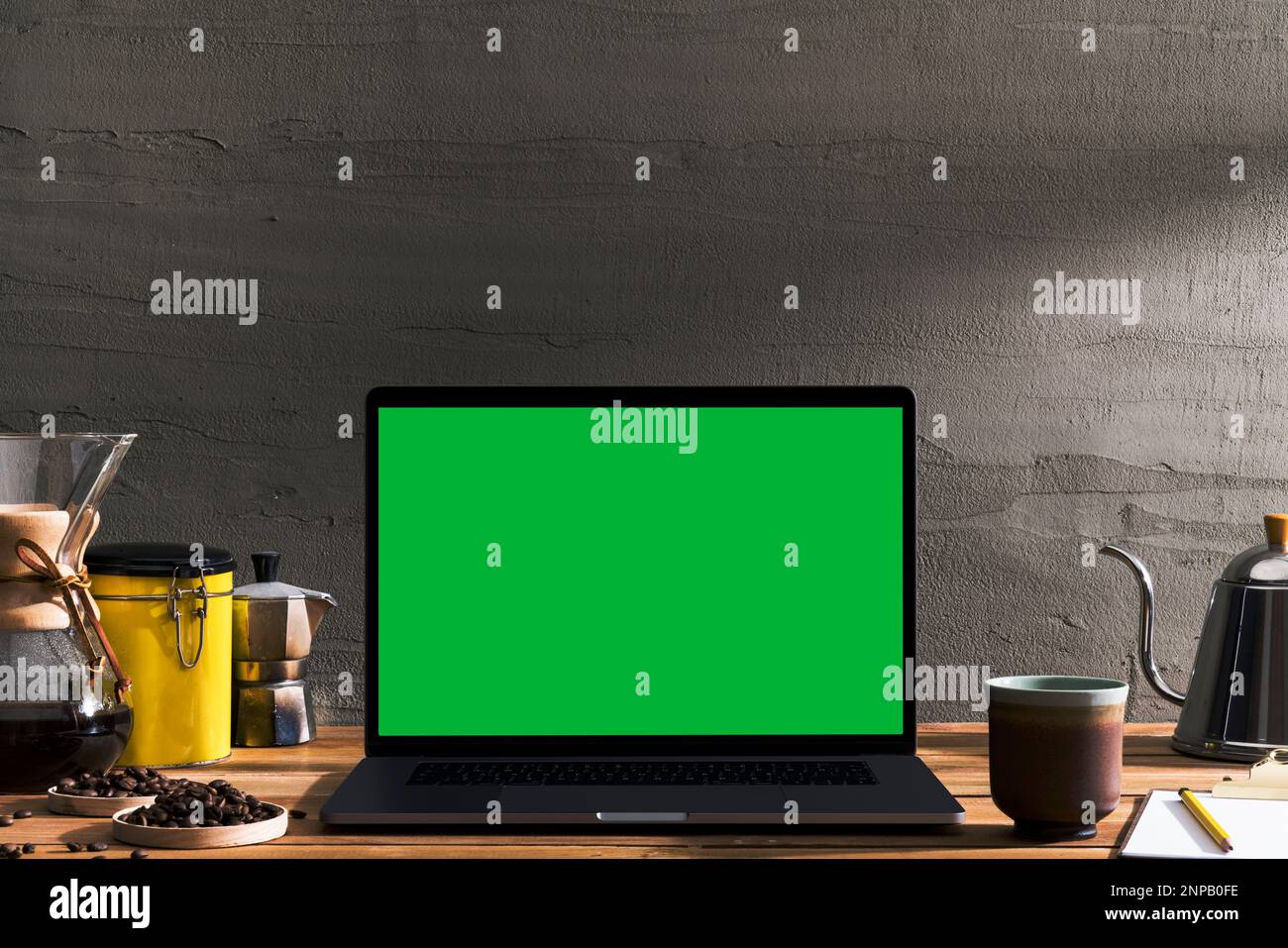 Chroma key green screen laptop and coffee brewing tools on wooden table ...