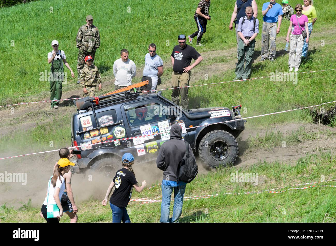 Crowd of spectators looking at the car "Suzuki Escudo" which is highly ...