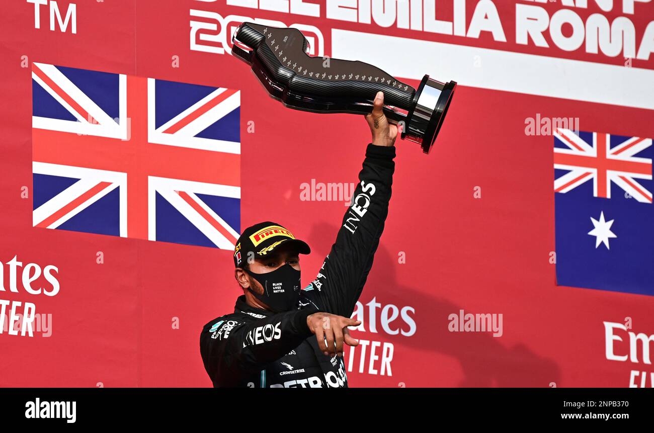 Mercedes driver Lewis Hamilton of Britain holds up the trophy on the ...