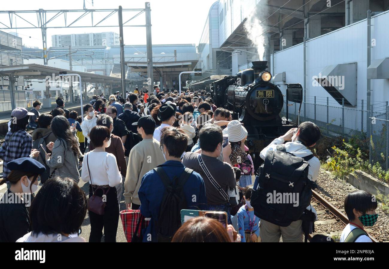 Kimetsu no Yaiba costume-clad fans pose with a steam locomotive (SL ...