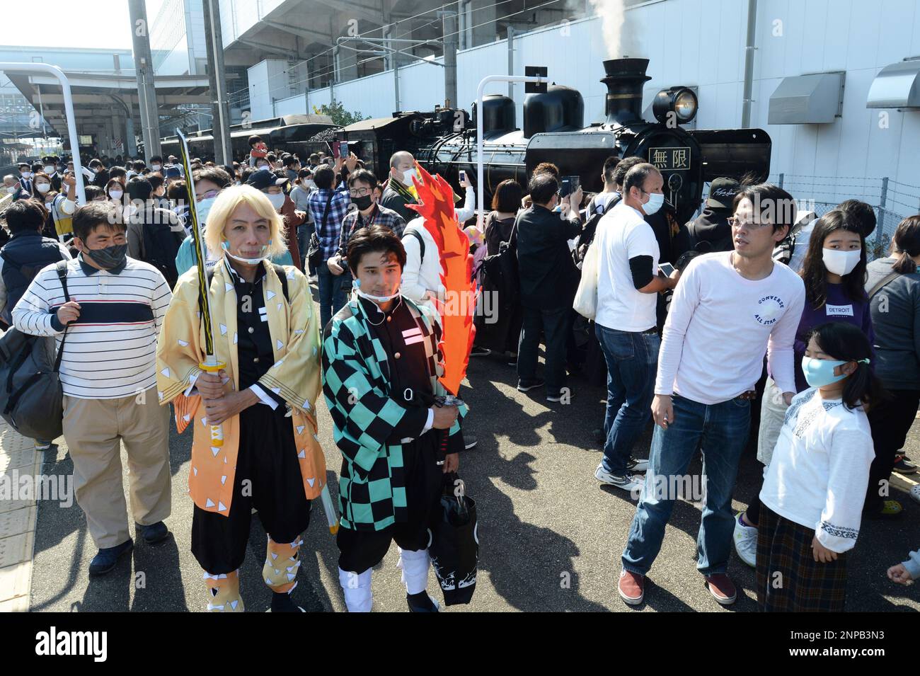 Kimetsu no Yaiba costume-clad fans pose with a steam locomotive (SL ...